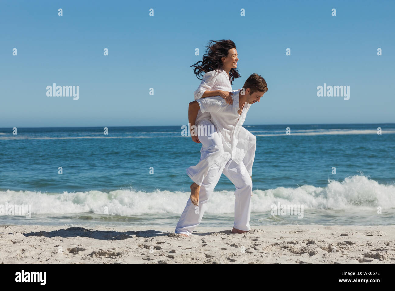 Happy adult caucasian couple having fun on the beach hi-res stock ...