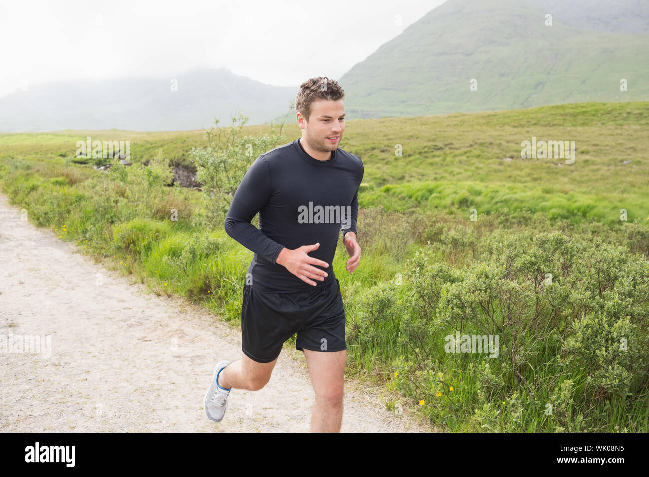 Fit man jogging on a trail Stock Photo - Alamy
