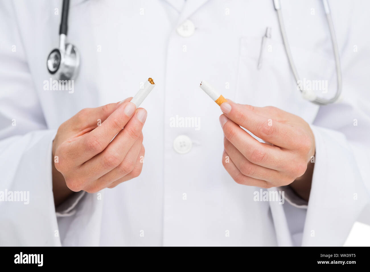 Doctor breaking cigarette Stock Photo - Alamy