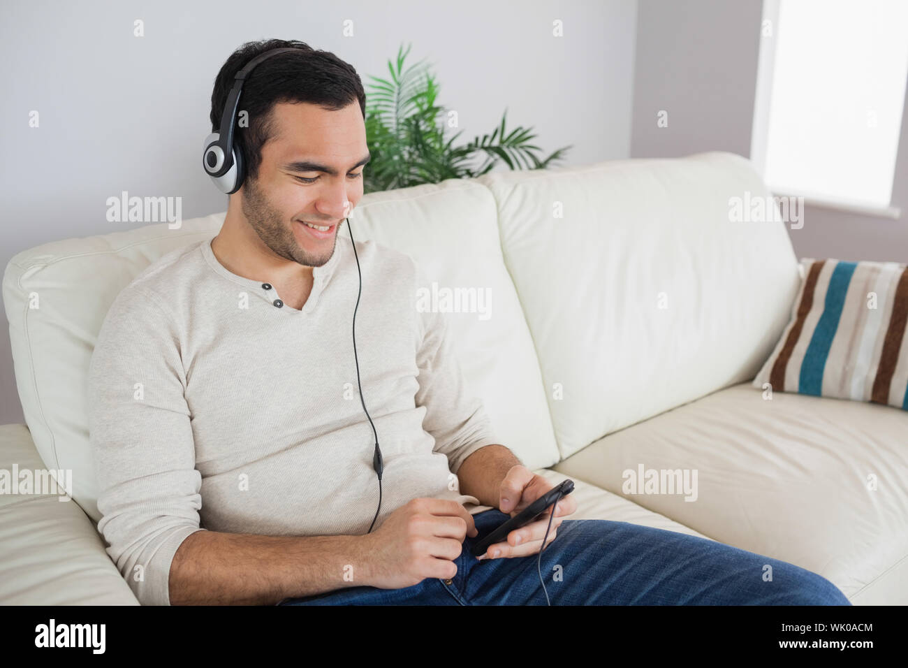 Smiling handsome man listening to music Stock Photo - Alamy