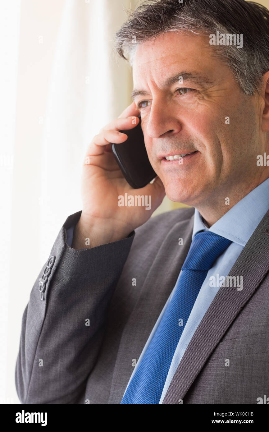 Serious man calling someone with his mobile phone Stock Photo - Alamy