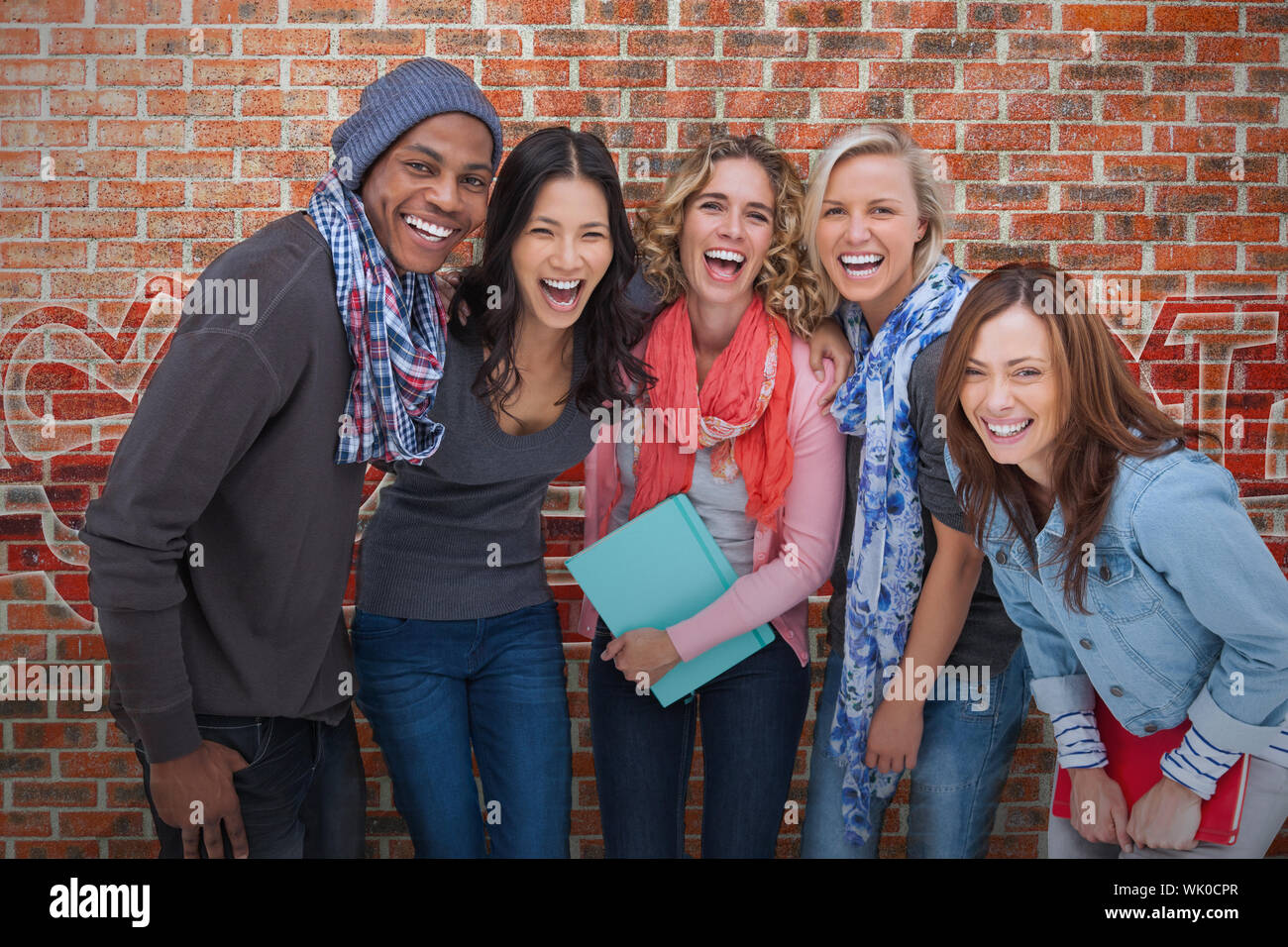 Fashionable students in a row smiling on white background Stock Photo ...