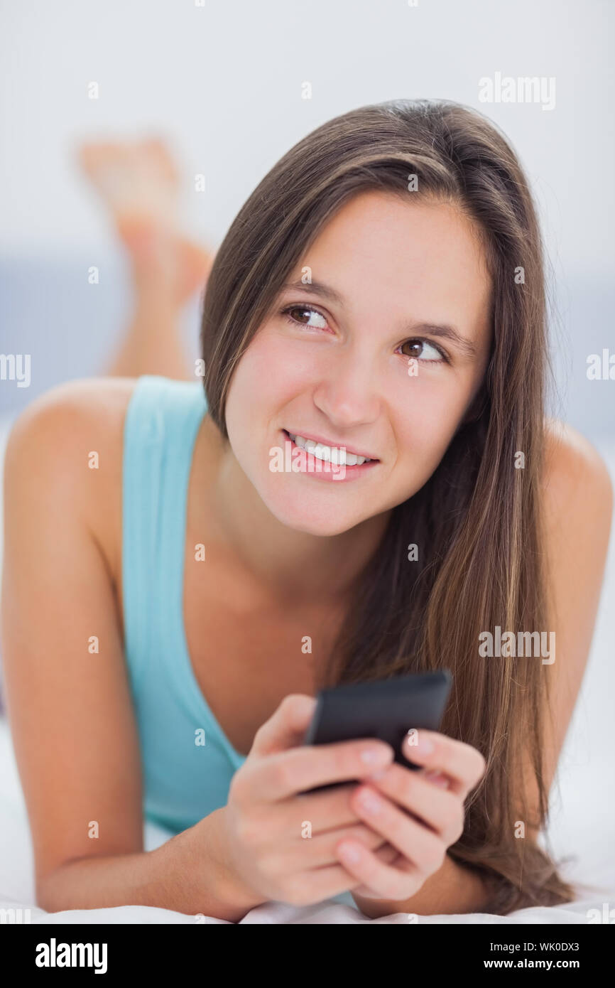 Woman smartphone thinking home hi-res stock photography and images - Alamy