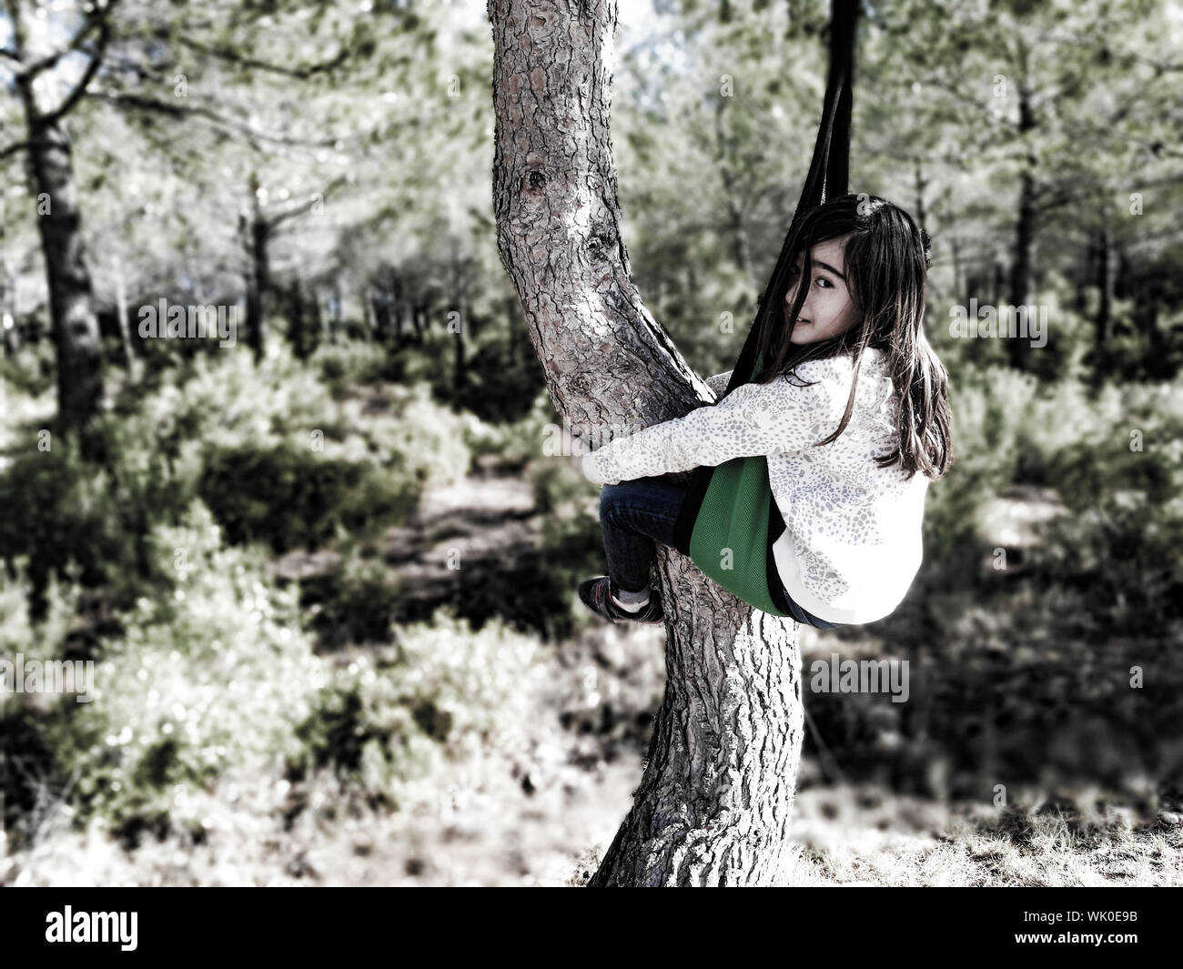 Tree children swinging hi-res stock photography and images - Alamy