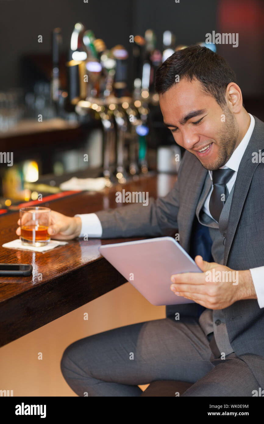 Happy businessman holding glass whiskey hi-res stock photography and ...