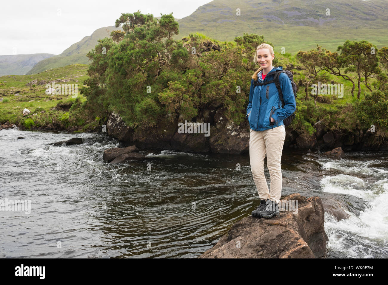 Woman standing on a rock hi-res stock photography and images - Alamy