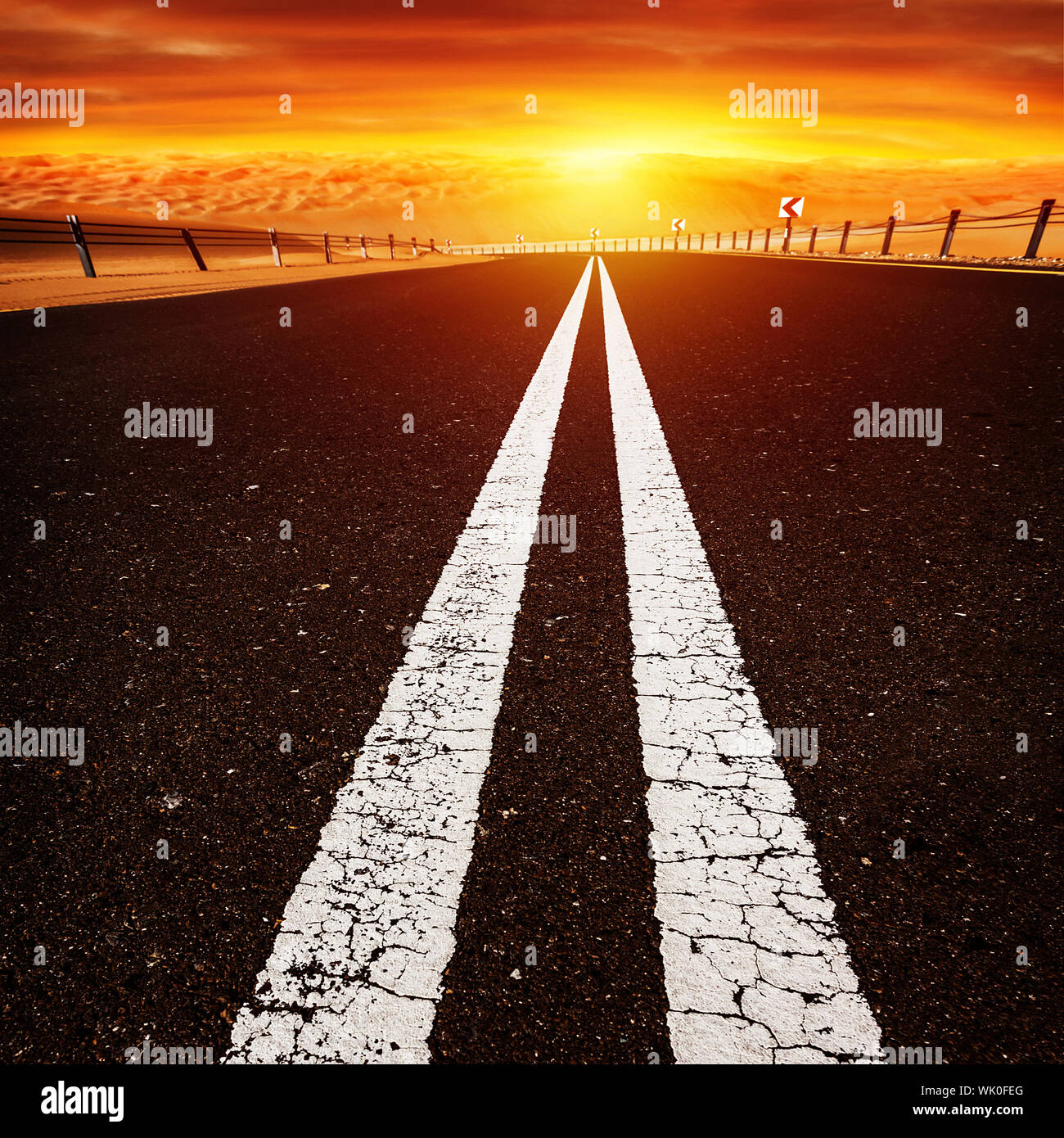 Road in red dramatic sunset, beautiful landscape, speed highway along ...