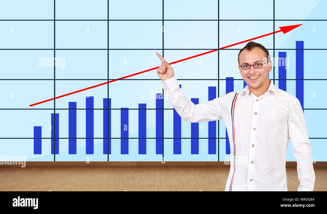 happy man pointing at graph on plasma wall Stock Photo - Alamy
