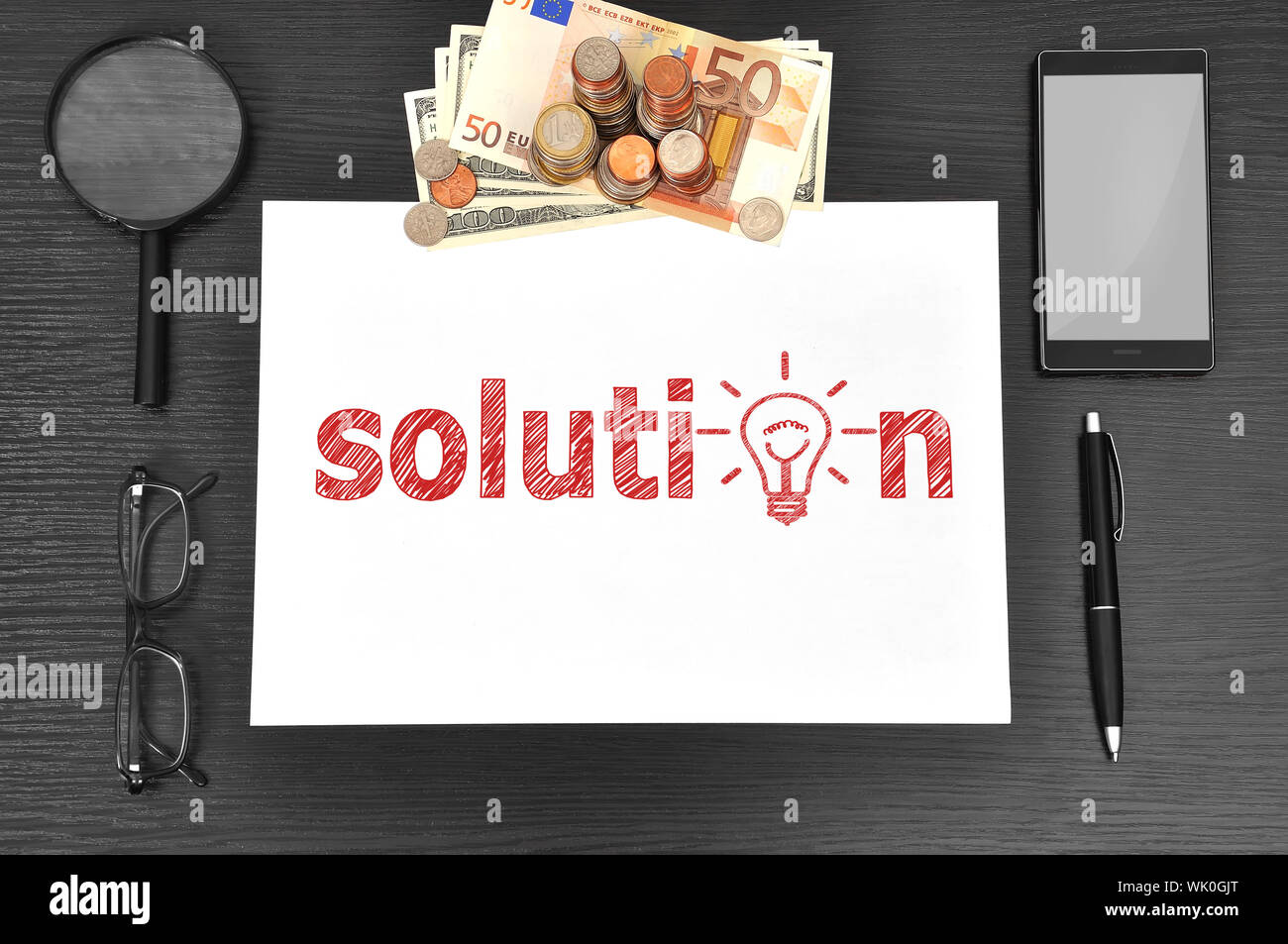 Office desktop, paper with solution and money Stock Photo - Alamy