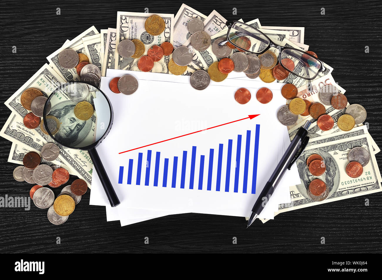 money on table and paper with chart Stock Photo - Alamy
