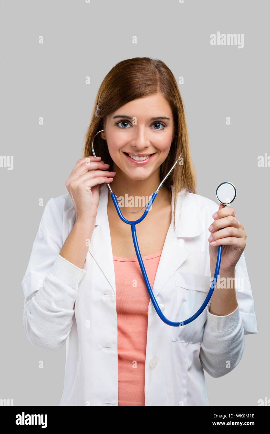 Beautiful and attractive female doctor, isolated over a white ...