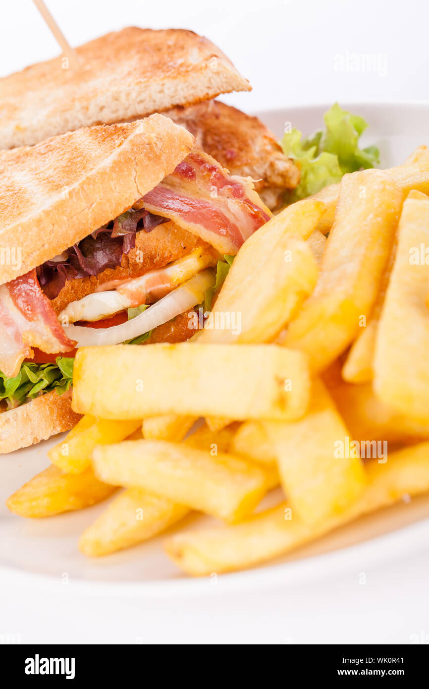 Club sandwich on toasted white bread with a meat filling served with ...