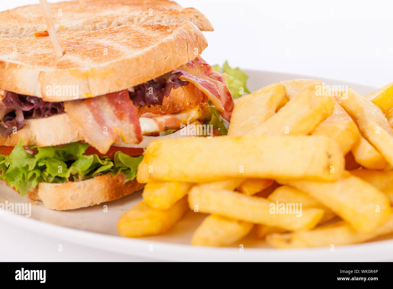 Club sandwich on toasted white bread with a meat filling served with ...