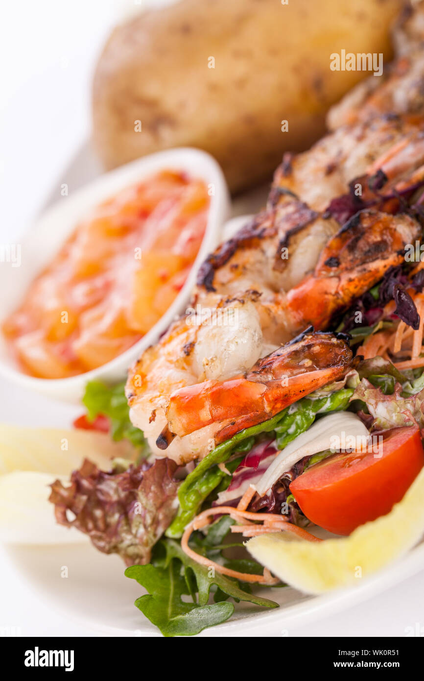 Grilled prawns with endive salad and jacket potato Stock Photo - Alamy