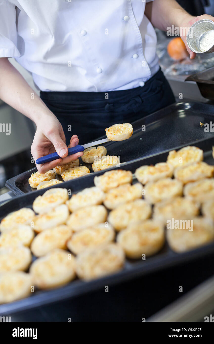 Chef preparing desserts removing them from individual ramekins or ...