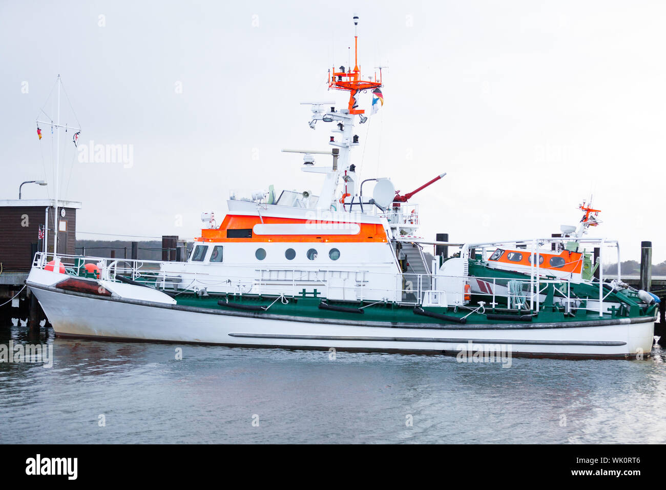 Cabin cruiser moored in a sheltered marine harbour with a neatly ...