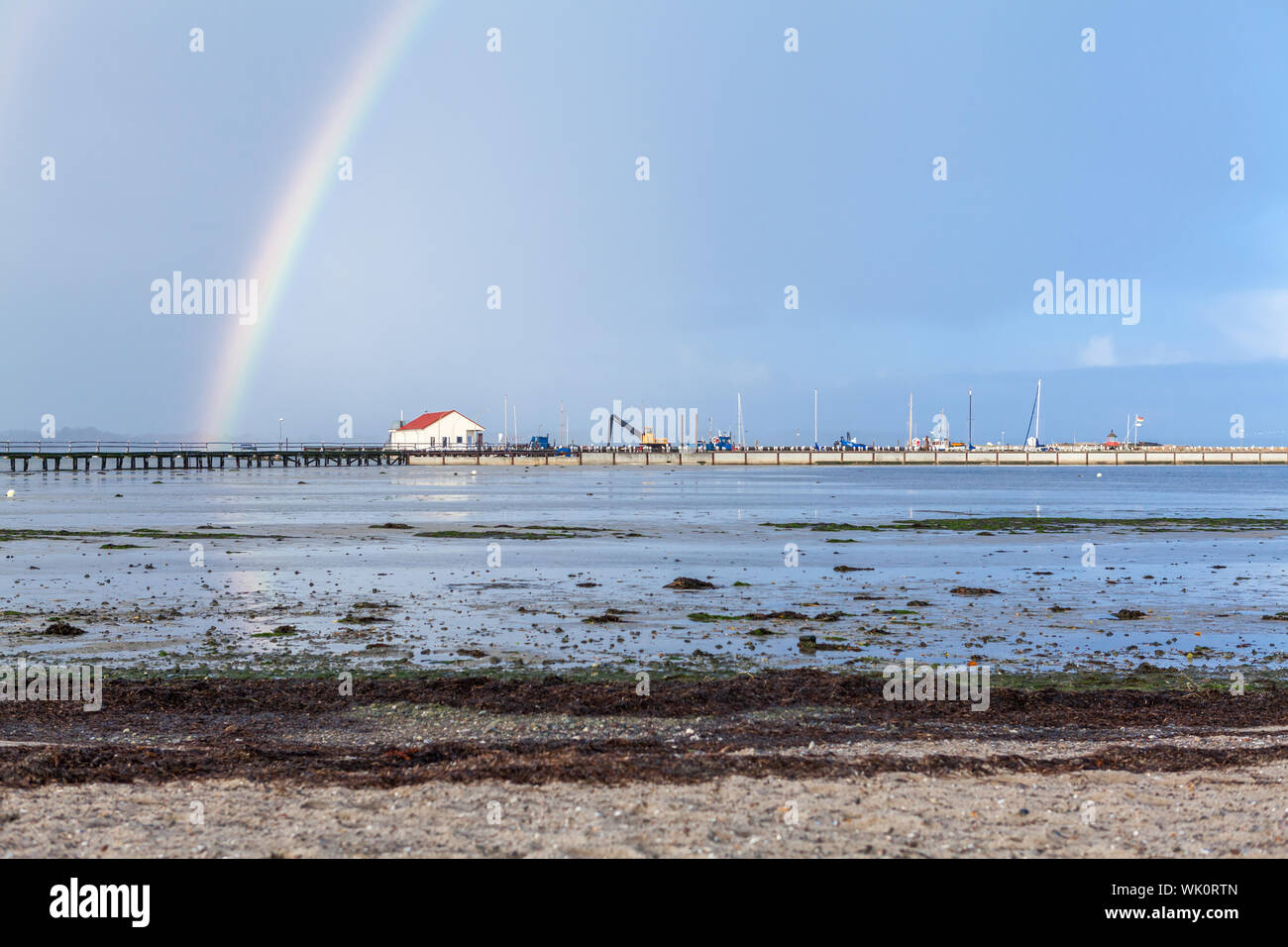Beautiful colourful rainbow in the colours of the spectrum arcing over ...