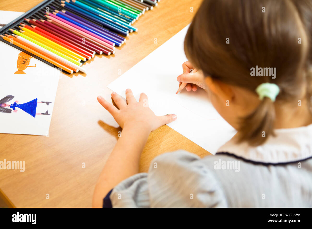 little girl playing with colors. The focus is on the hand drawing Stock ...