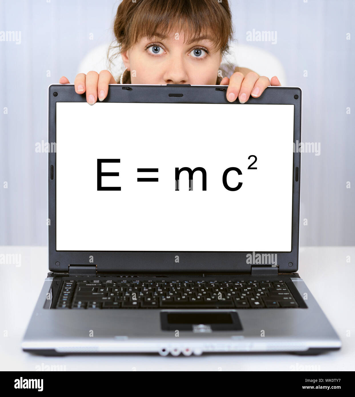 Young woman shows us a computer screen with formula Stock Photo - Alamy
