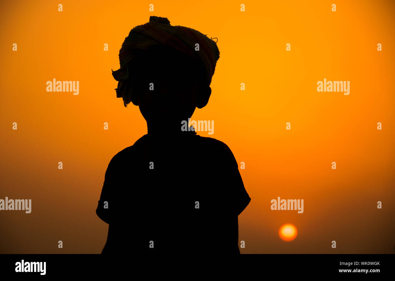 A cute sunset with a young boy shadow Stock Photo - Alamy