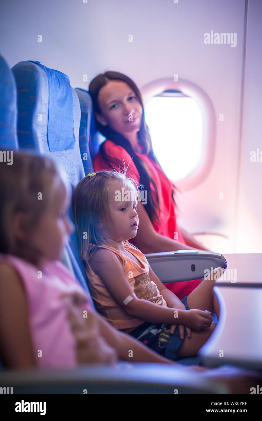 Young family in the airplane Stock Photo - Alamy