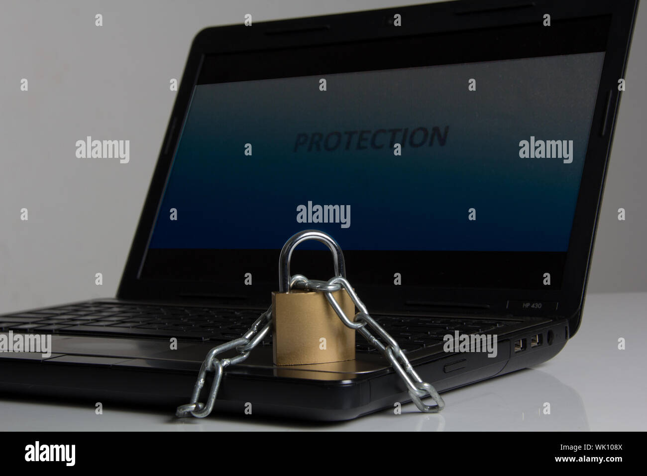 Chain and lock on laptop Stock Photo - Alamy