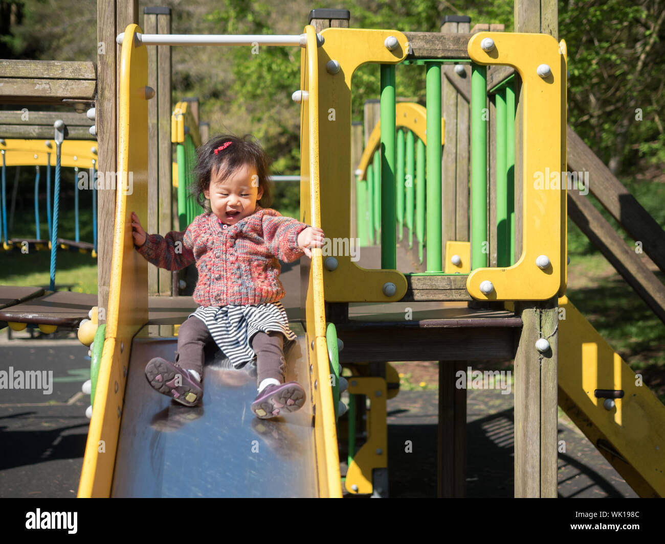 Toddler playing on slide hi-res stock photography and images - Alamy