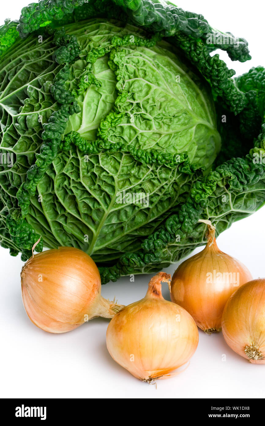 fresh savoy cabbage and five onions closeup on white background Stock ...