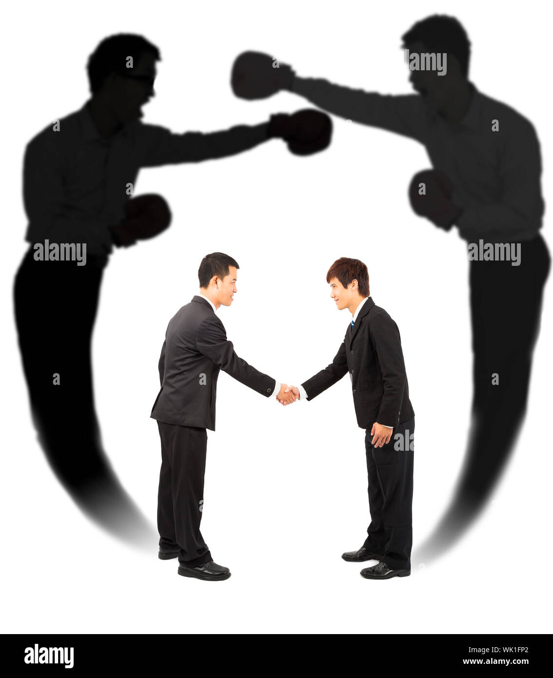 Two businessman handshake with fighting shadow Stock Photo - Alamy