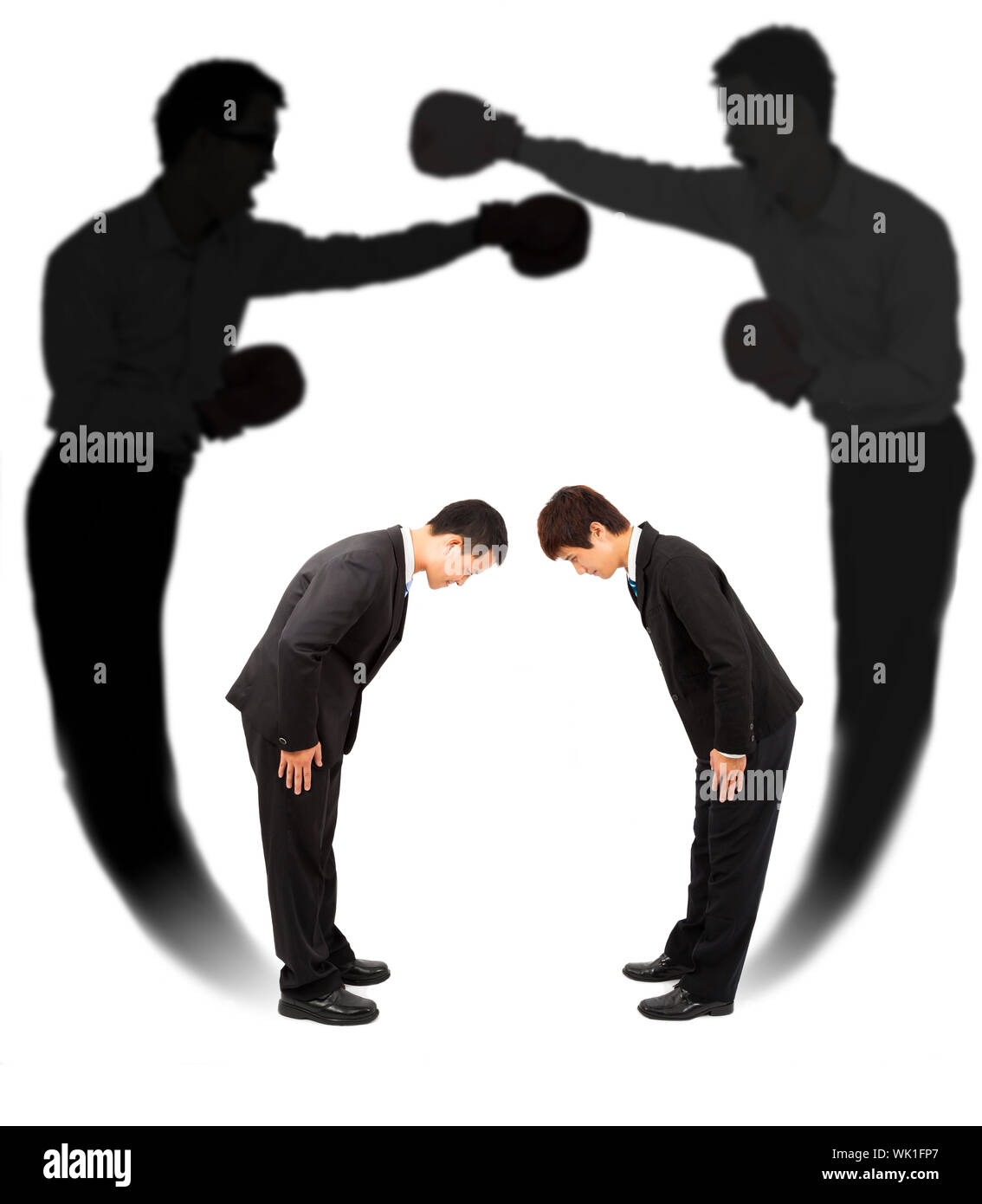 Two businessman bow each other with fighting shadow Stock Photo - Alamy