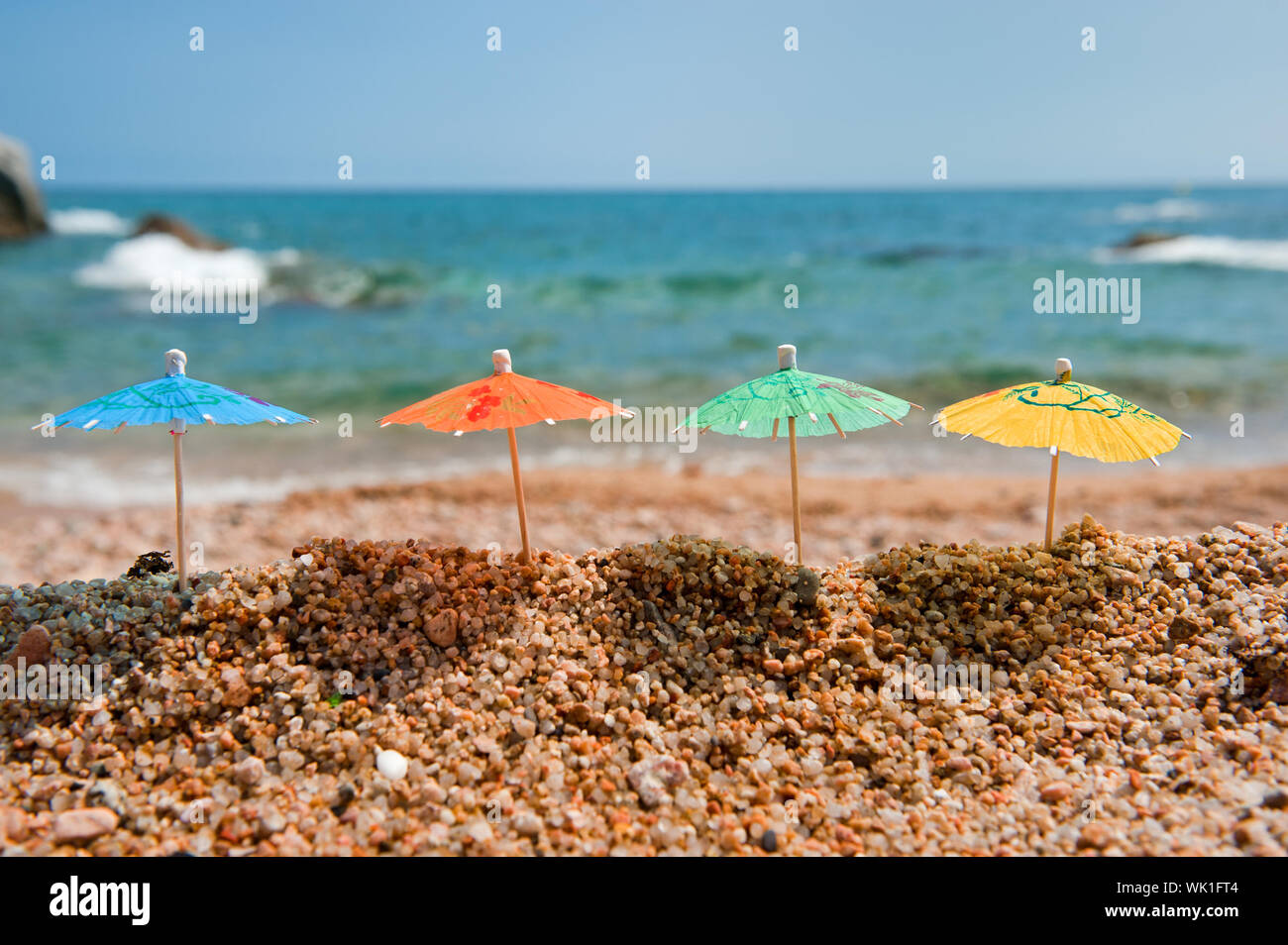 A row with colorful little parasols for shade at the beach Stock Photo ...