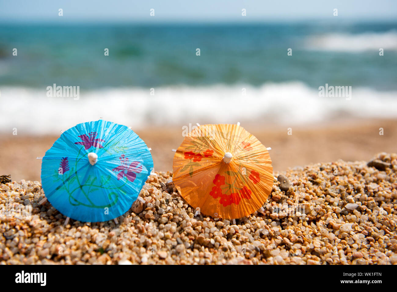 A row with colorful little parasols for shade at the beach Stock Photo ...