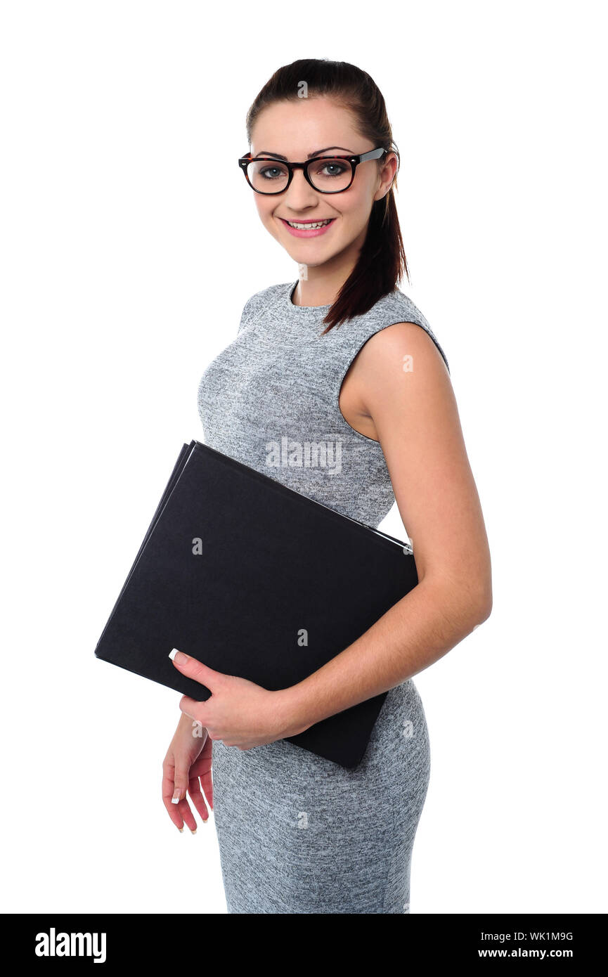 Young female executive posing with files Stock Photo - Alamy