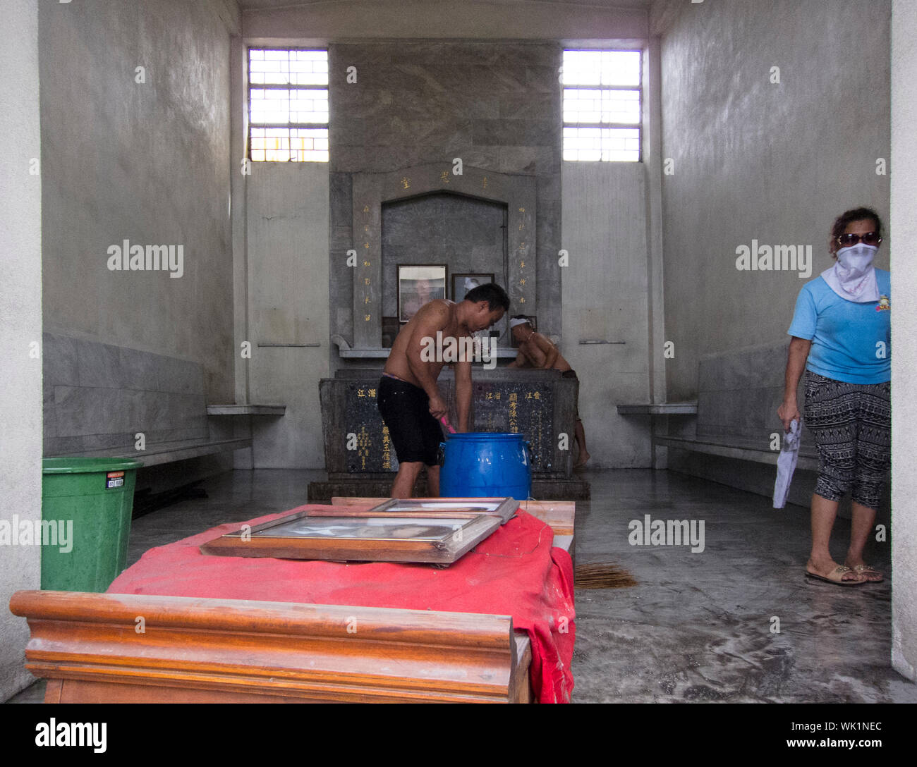 A cleaning crew working inside a typical mausoleum at the Chinese North ...