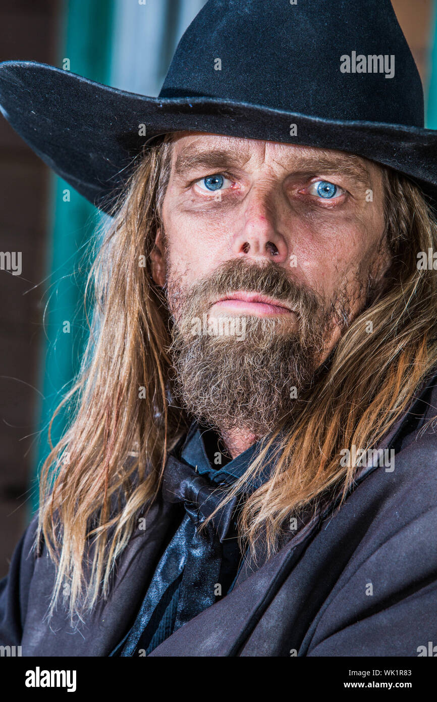 Portrait of a gruff looking old west bandit Stock Photo - Alamy