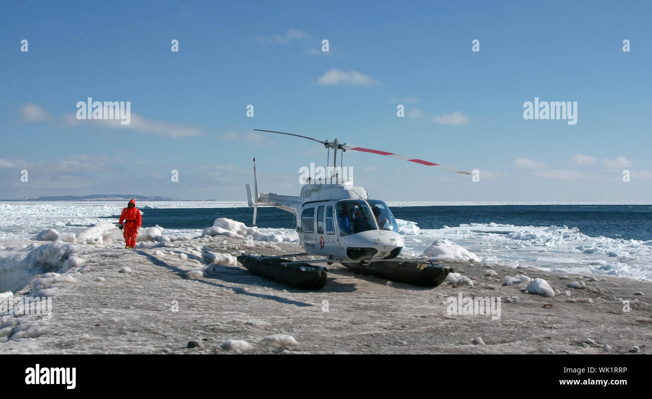 Scientists by a helicopter in the Canadian Arctic Stock Photo - Alamy