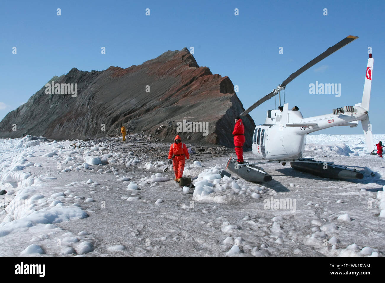 Scientists by a helicopter in the Canadian Arctic Stock Photo - Alamy