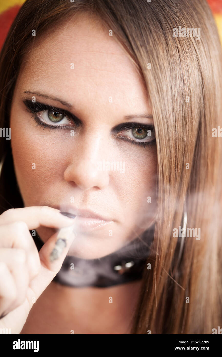 portrait of young female smoking a joint Stock Photo - Alamy
