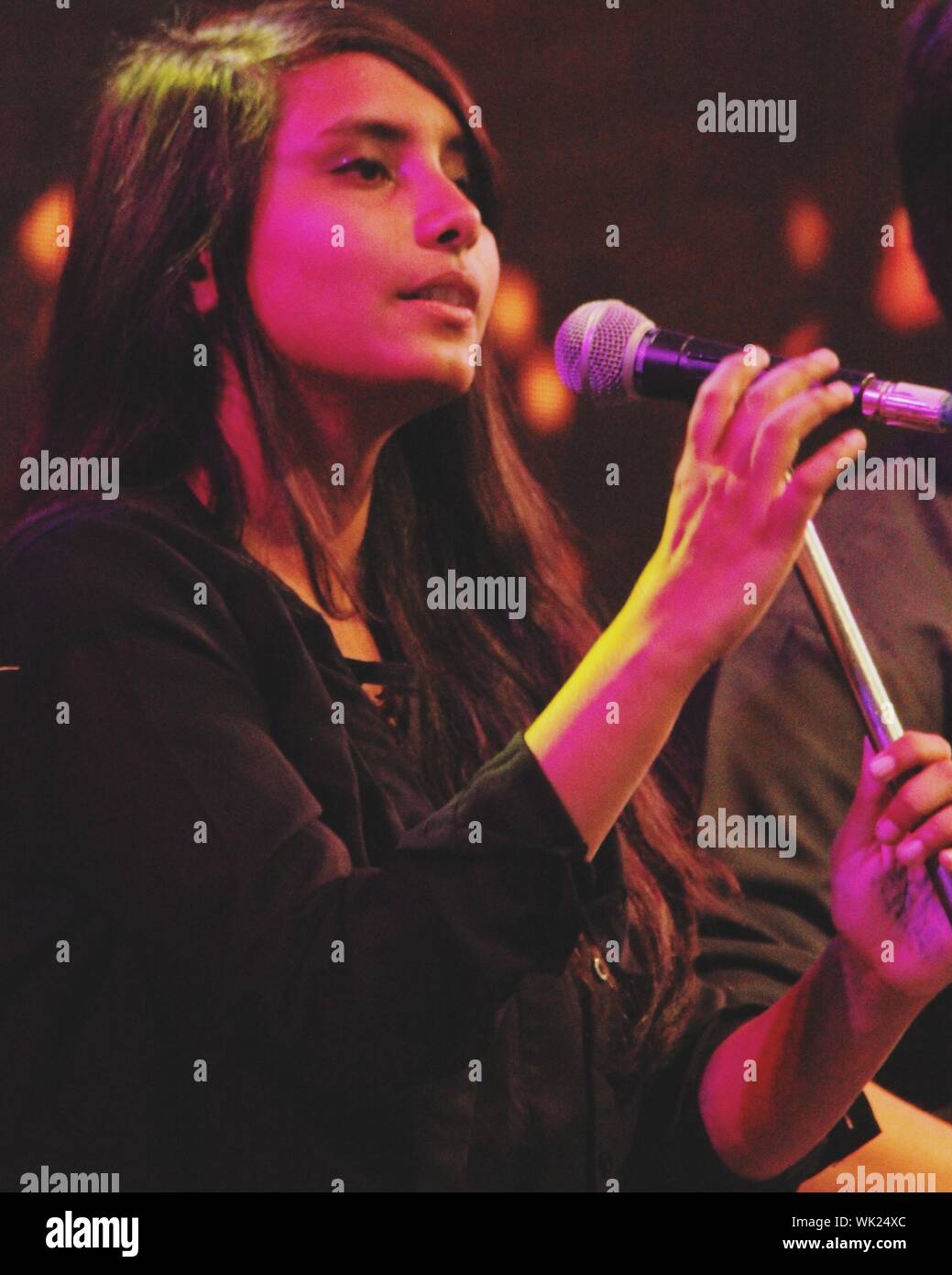 Indian woman singing microphone hi-res stock photography and images - Alamy