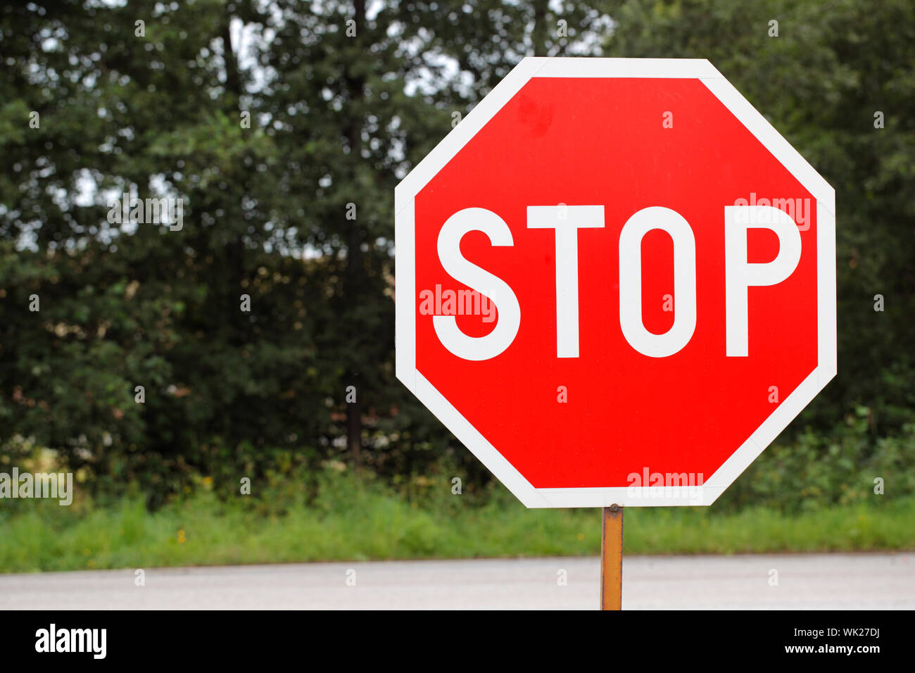 old STOP traffic sign at the side of a road Stock Photo - Alamy