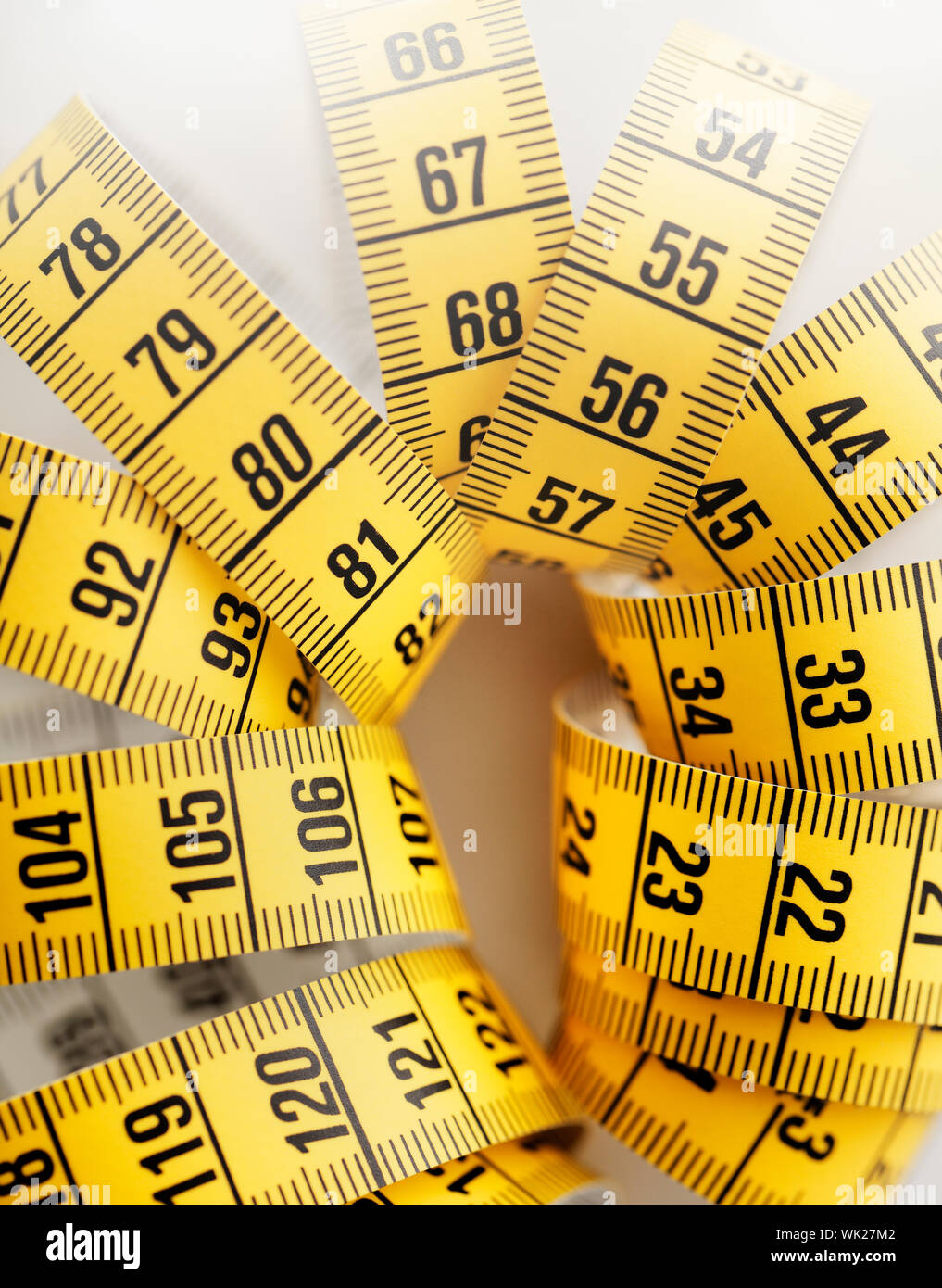 Yellow metric tape measure. Short depth-of-field Stock Photo - Alamy