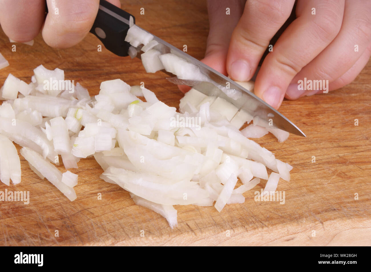 cut one organic onion, two hands and a knife Stock Photo - Alamy