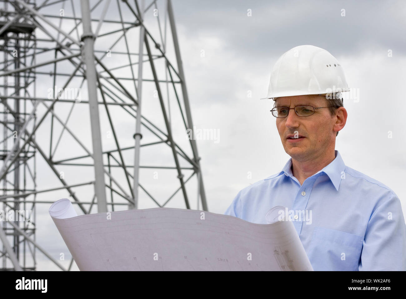 Engineer reading a plan on construction side Stock Photo - Alamy