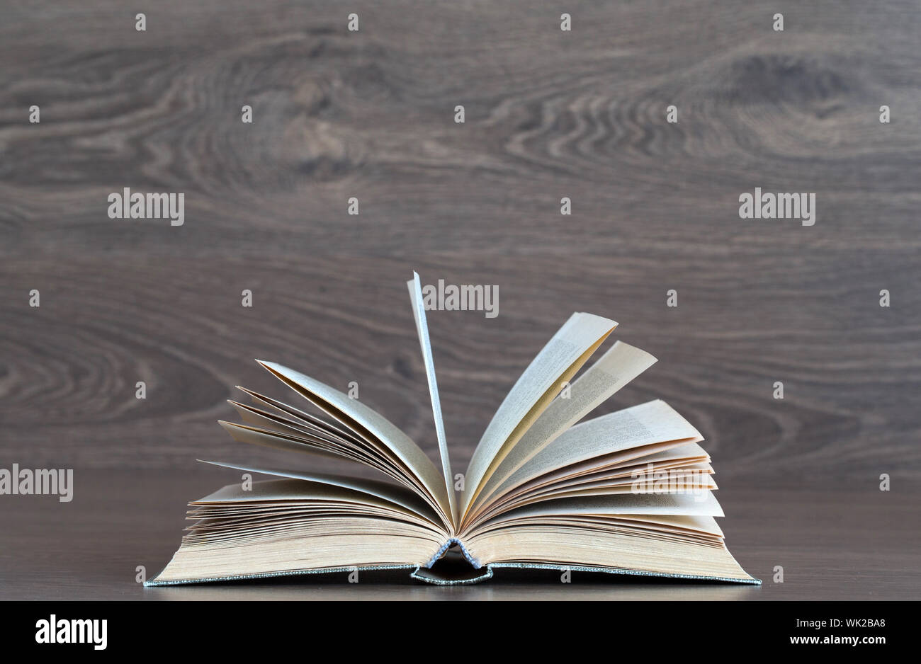 Open book on wood background Stock Photo - Alamy