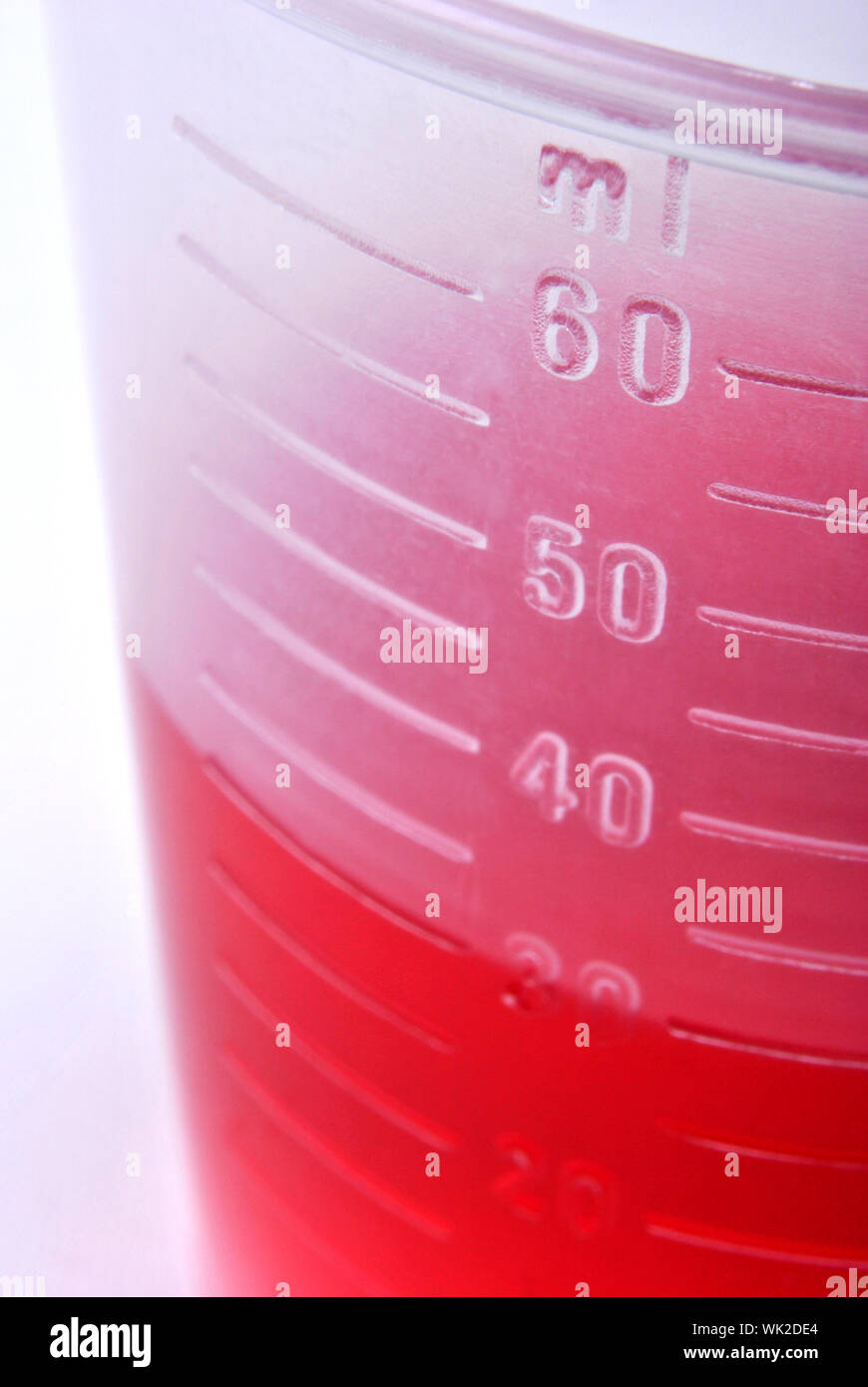 30 ml red liquid as medicine in a small container Stock Photo - Alamy