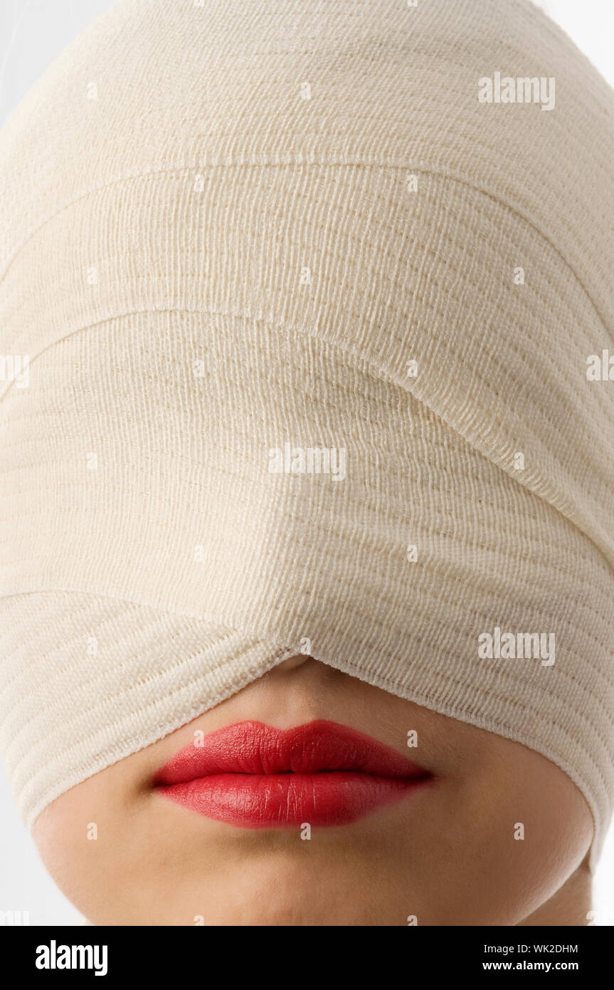 close up of woman with bandage around face and red lips Stock Photo - Alamy