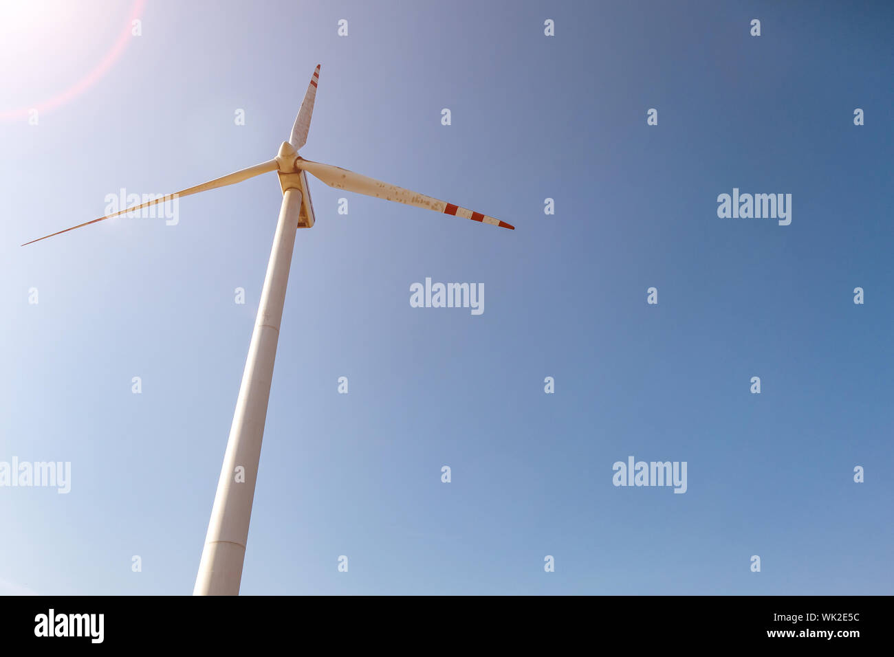 rotating blades of a windmill propeller on blue sky background. Wind ...