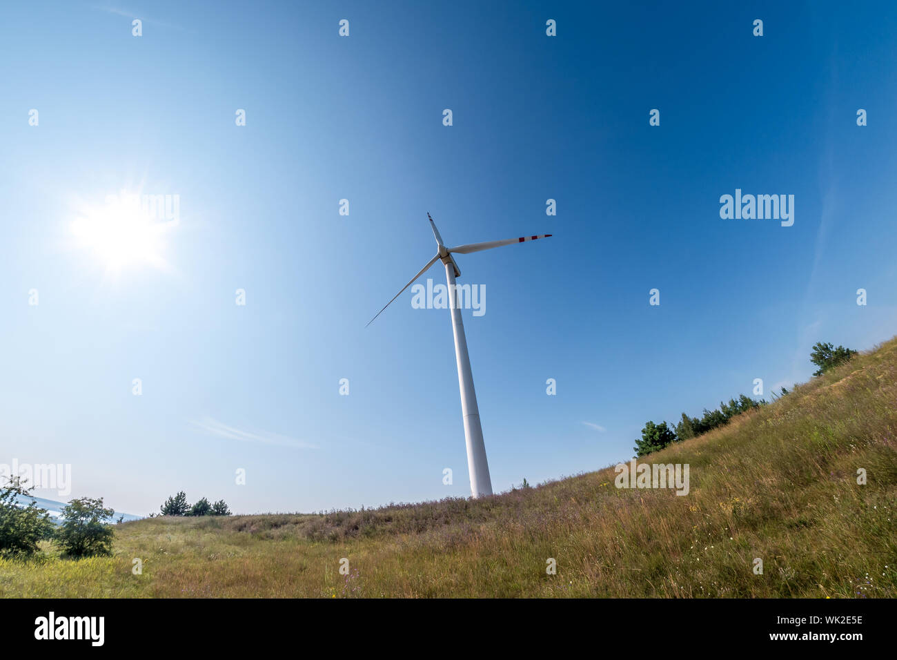 rotating blades of a windmill propeller on blue sky background. Wind ...