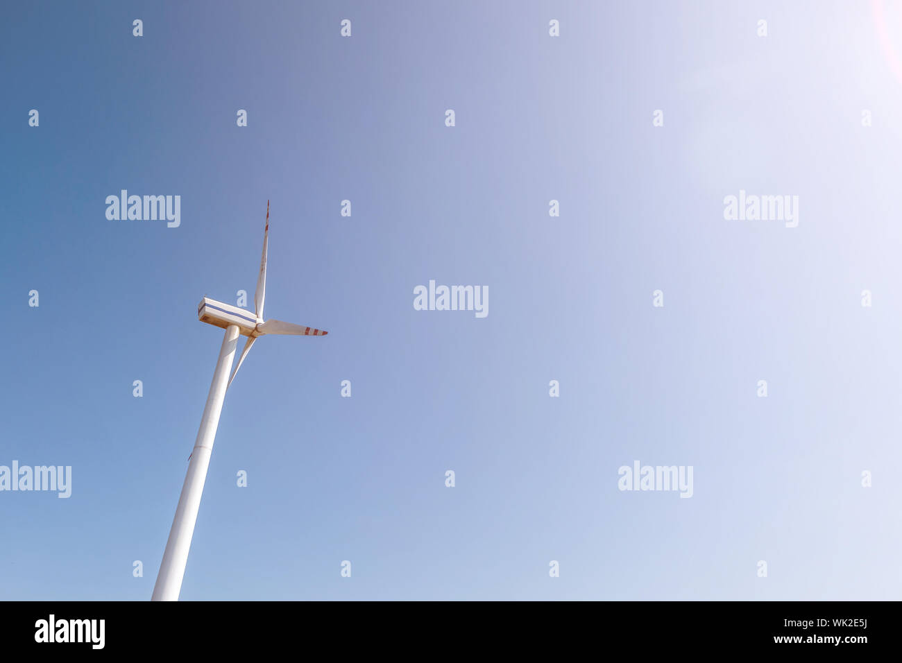 rotating blades of a windmill propeller on blue sky background. Wind ...