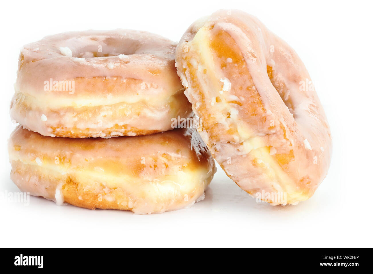 Stacked of glazed donuts isolated over a white background with slight ...